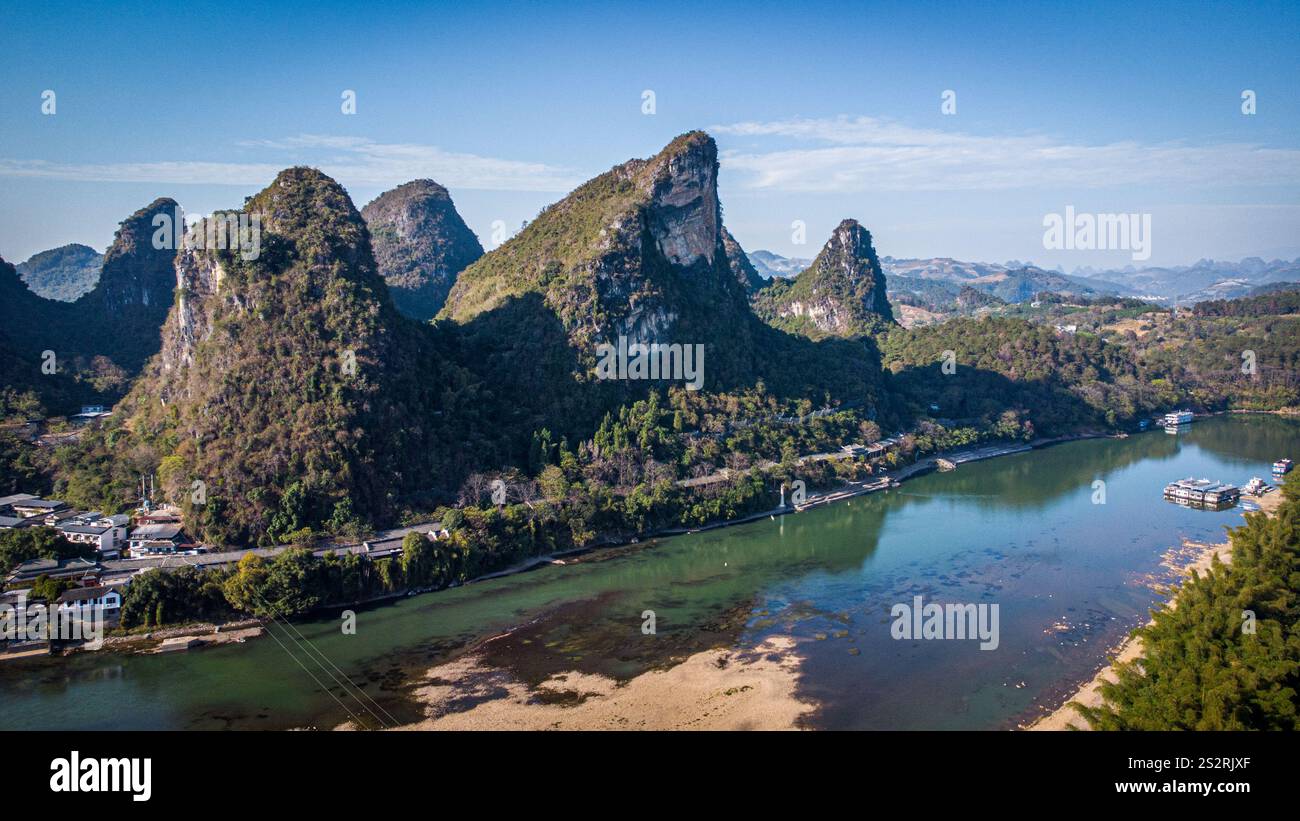 Aerial view of Li river surrounded by karst mountains and lush trees ...