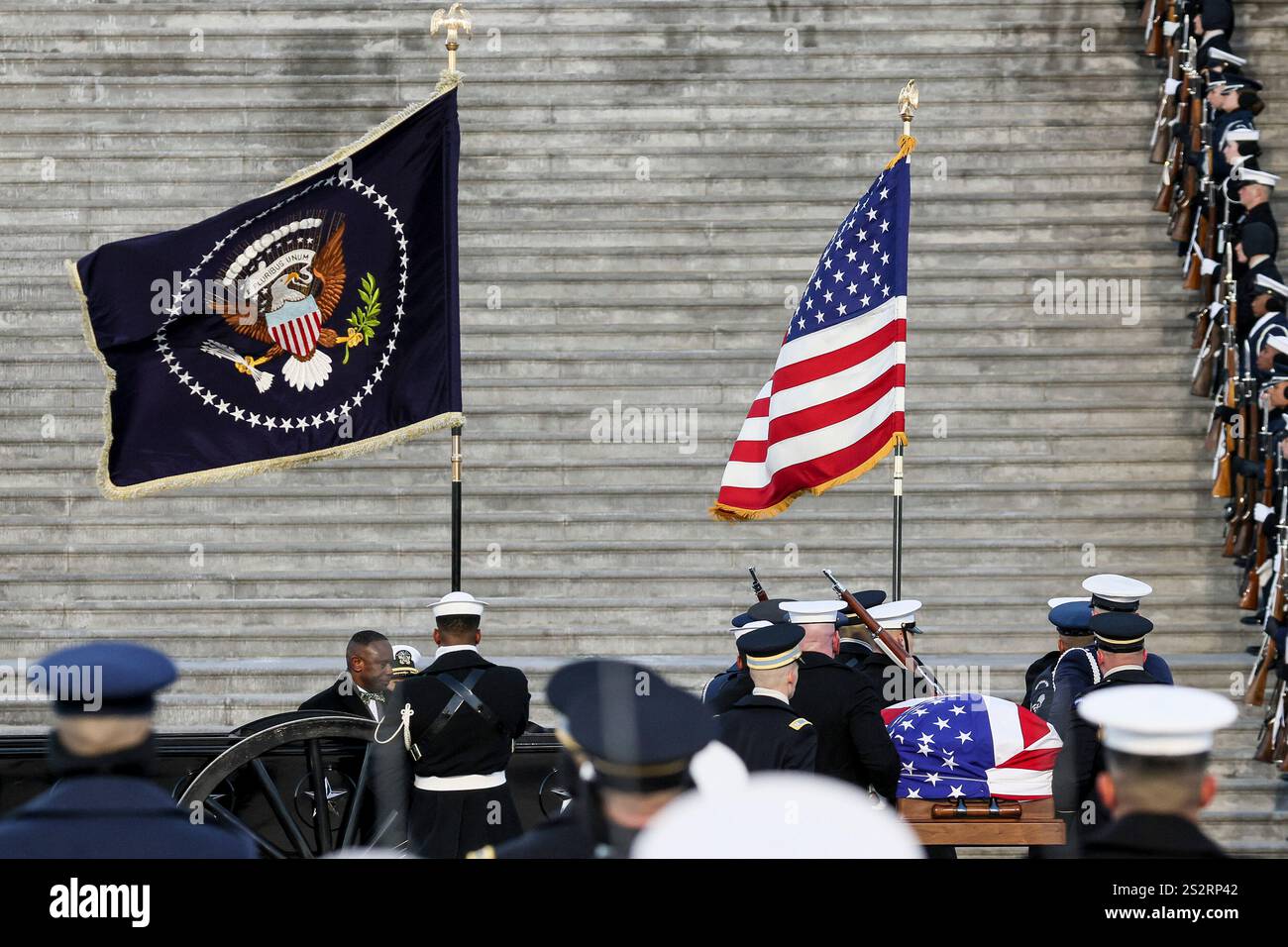 U.S. Military joint force pallbearers carry the flag-draped casket of ...