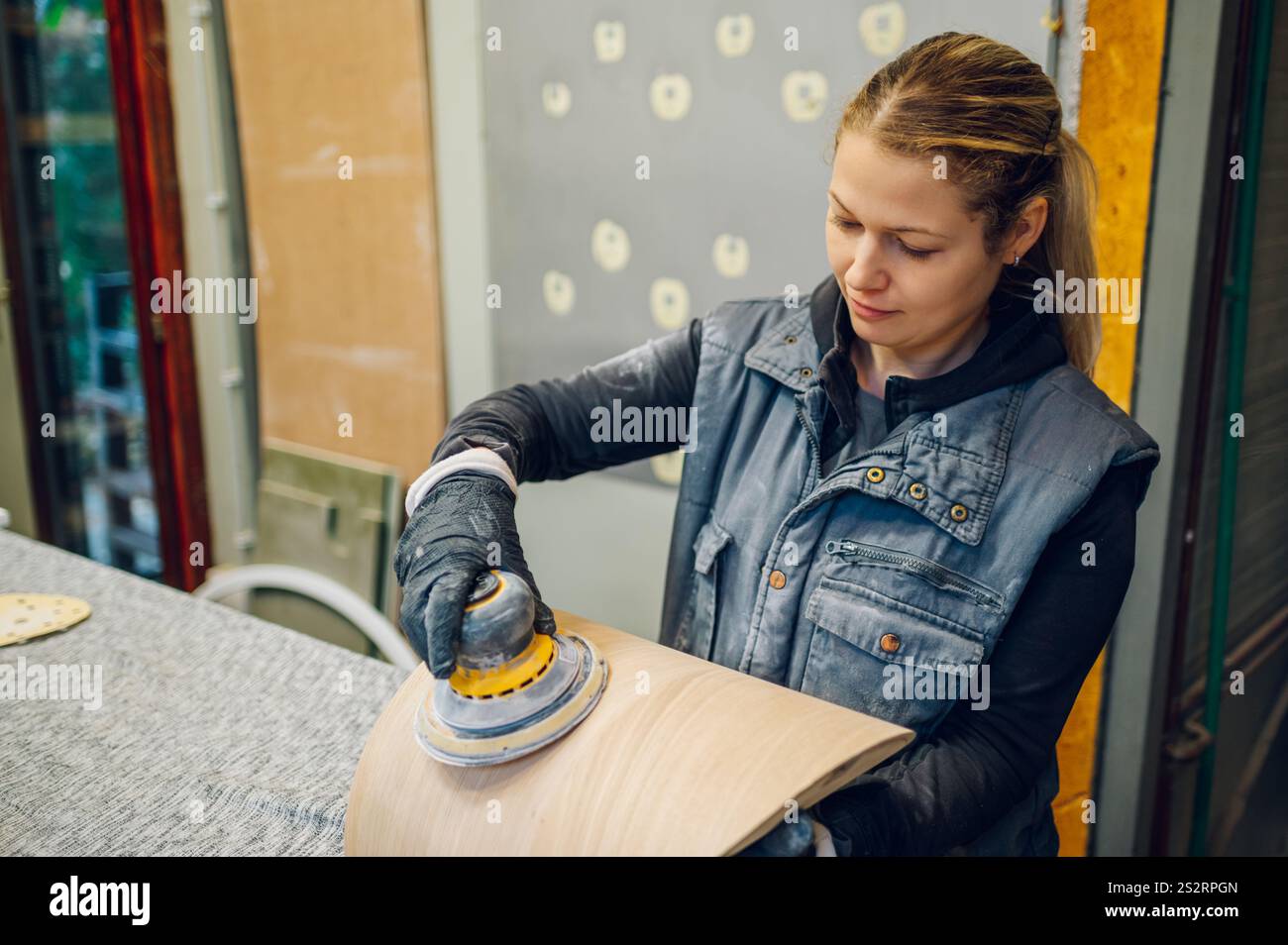 Portrait of a woman worker engineer carpenter wears safety gloves using ...