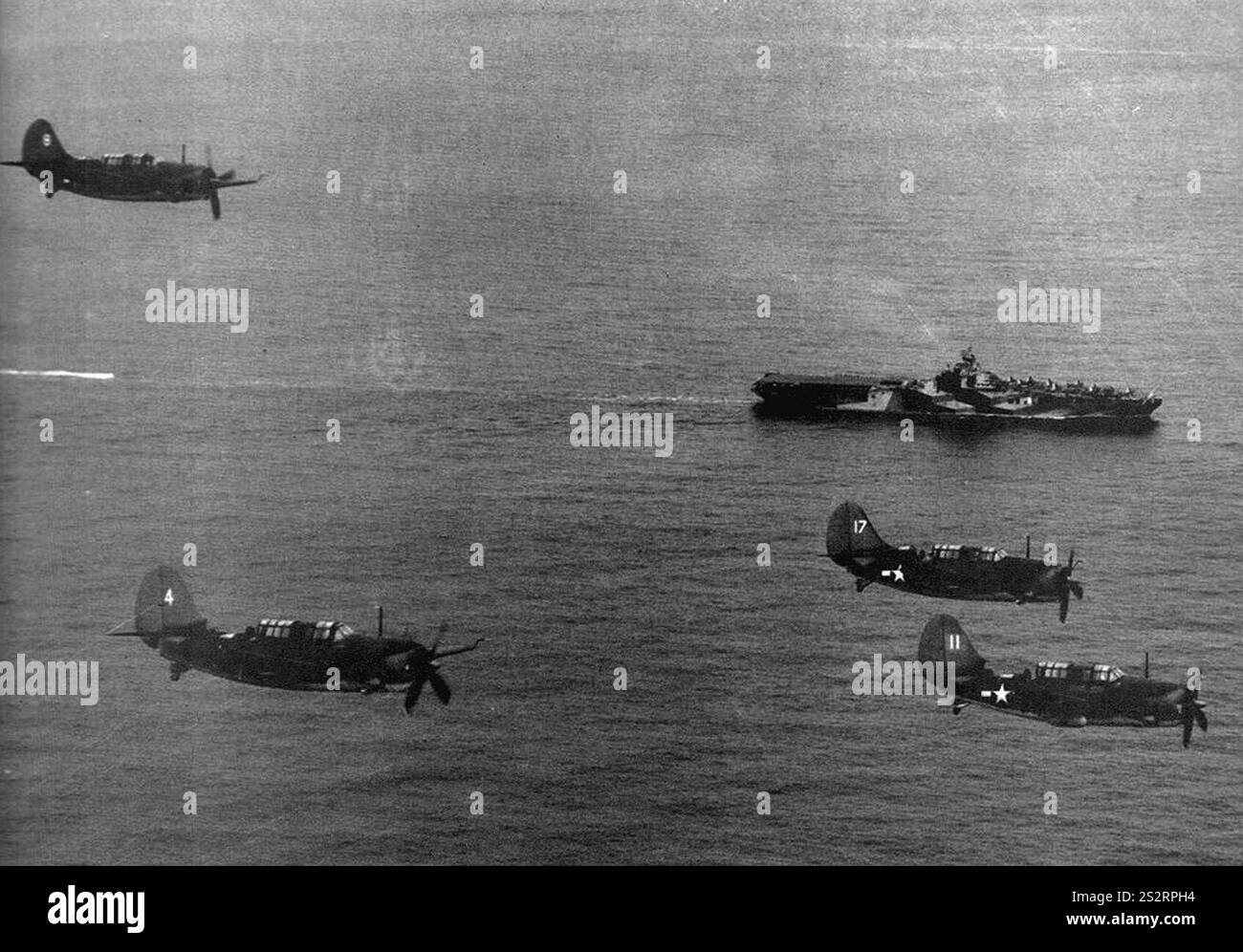 Four Curtiss SB2C-3 Helldiver of VB-6 in flight over USS Hancock (CV-19 ...