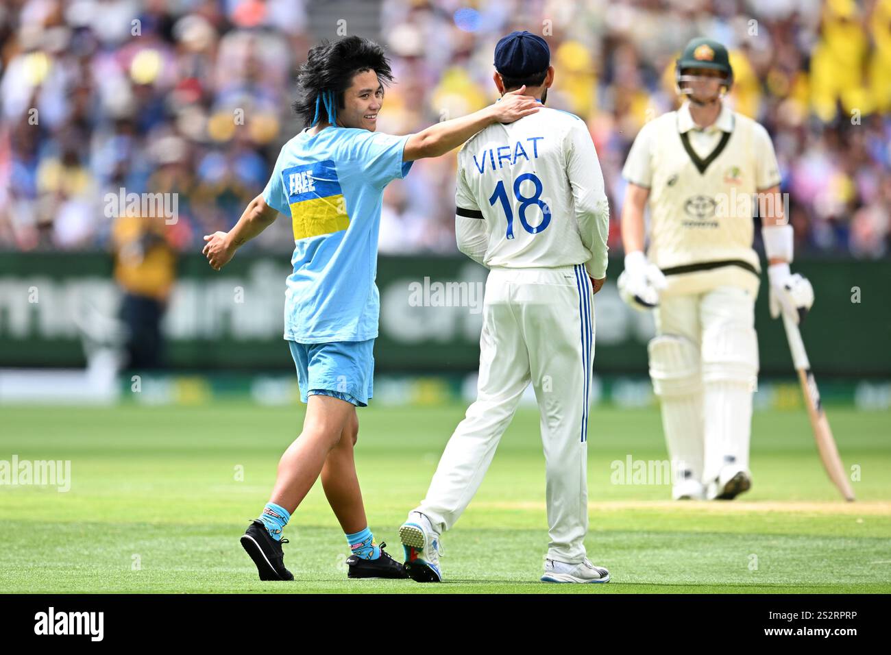 Melbourne, Australia. 27th Dec, 2024. A pitch invader with Virat Kohli ...