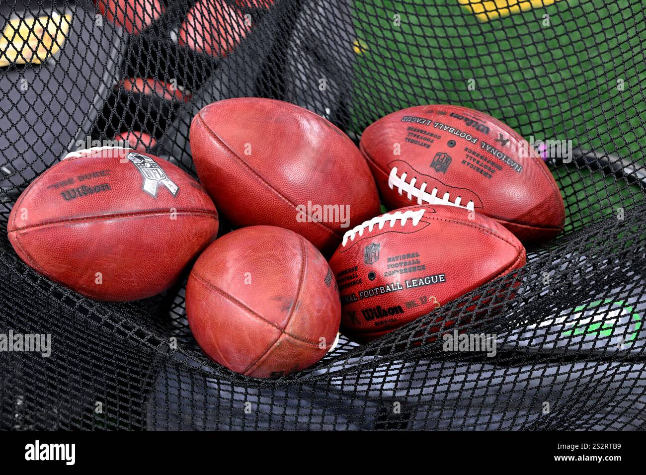 Various NFL game balls are seen before an NFL football game between the ...
