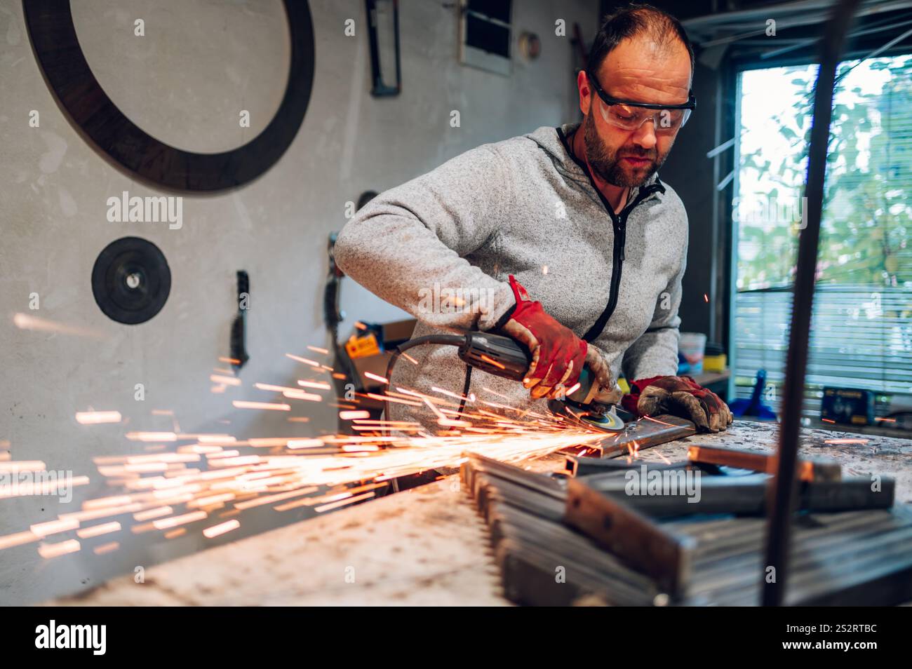 Portrait of a man worker making the structure of a metal profile while ...