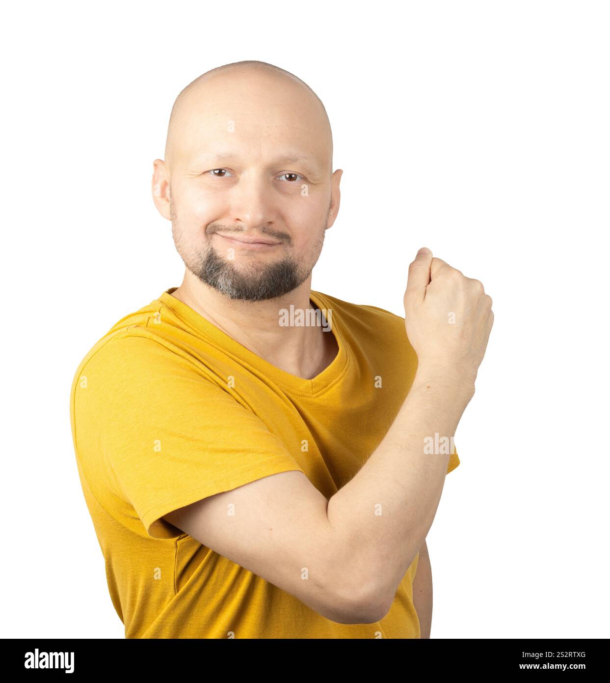 A bald man with a beard is wearing a yellow shirt and raising his fist ...
