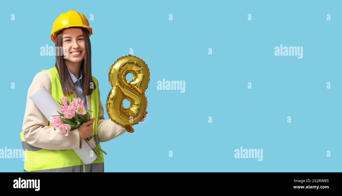 Female construction worker holding balloon in shape of figure 8 and ...