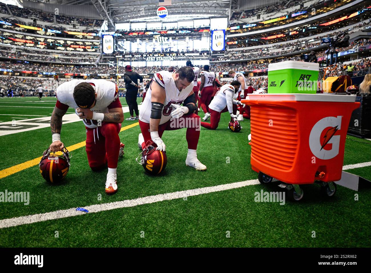 Washington Commanders guard Nick Allegretti (67) takes a knee with his ...