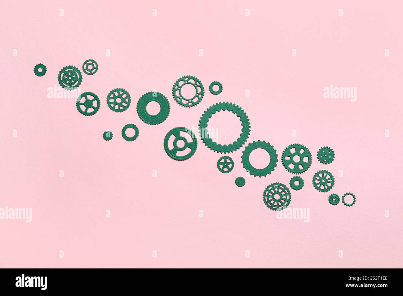 Green paper gears on pink background Stock Photo - Alamy