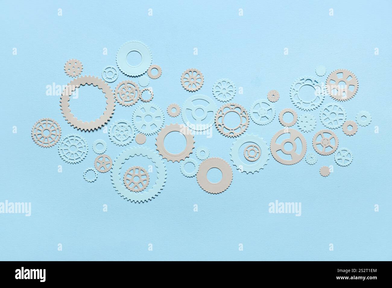 Different paper gears on blue background Stock Photo - Alamy
