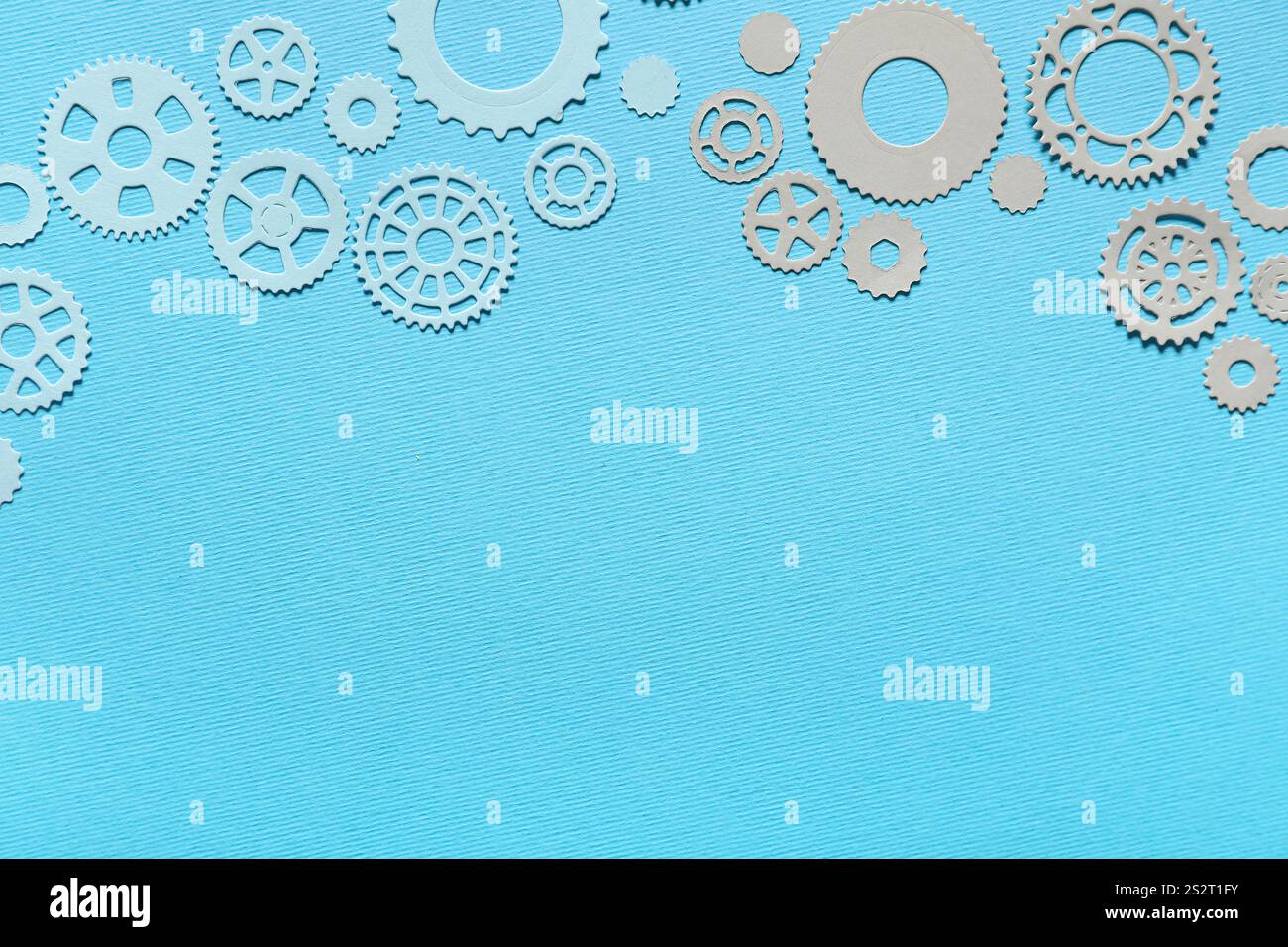 Different paper gears on blue background Stock Photo - Alamy