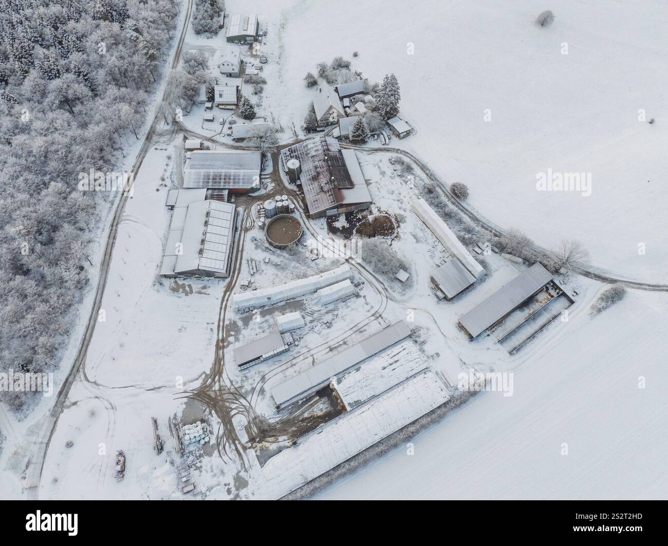 Aerial view of a snow-covered farm with buildings and fields ...