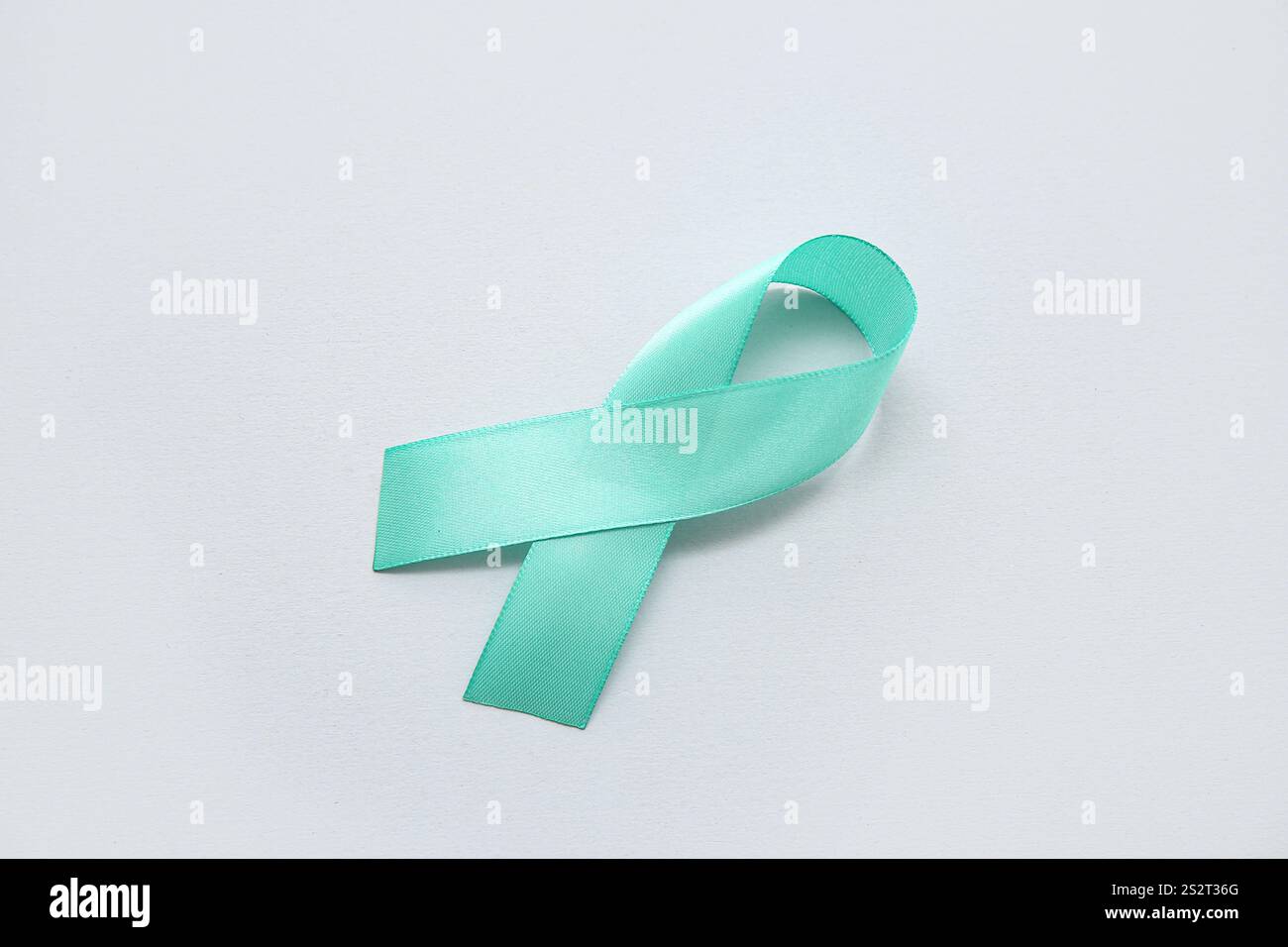 Turquoise ribbon on white background. Cervical Health Awareness Month ...