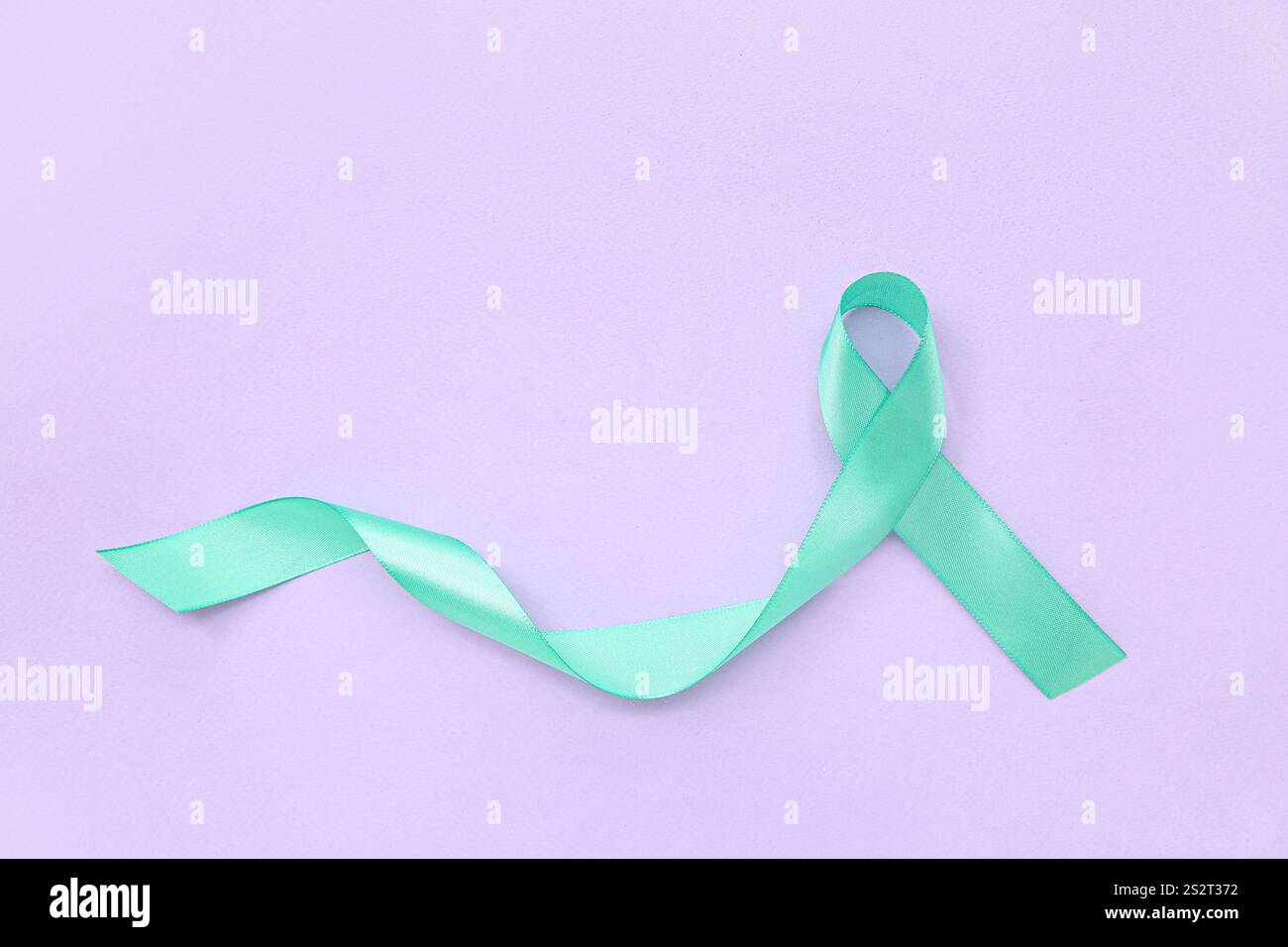 Turquoise ribbon on lilac background. Cervical Health Awareness Month ...