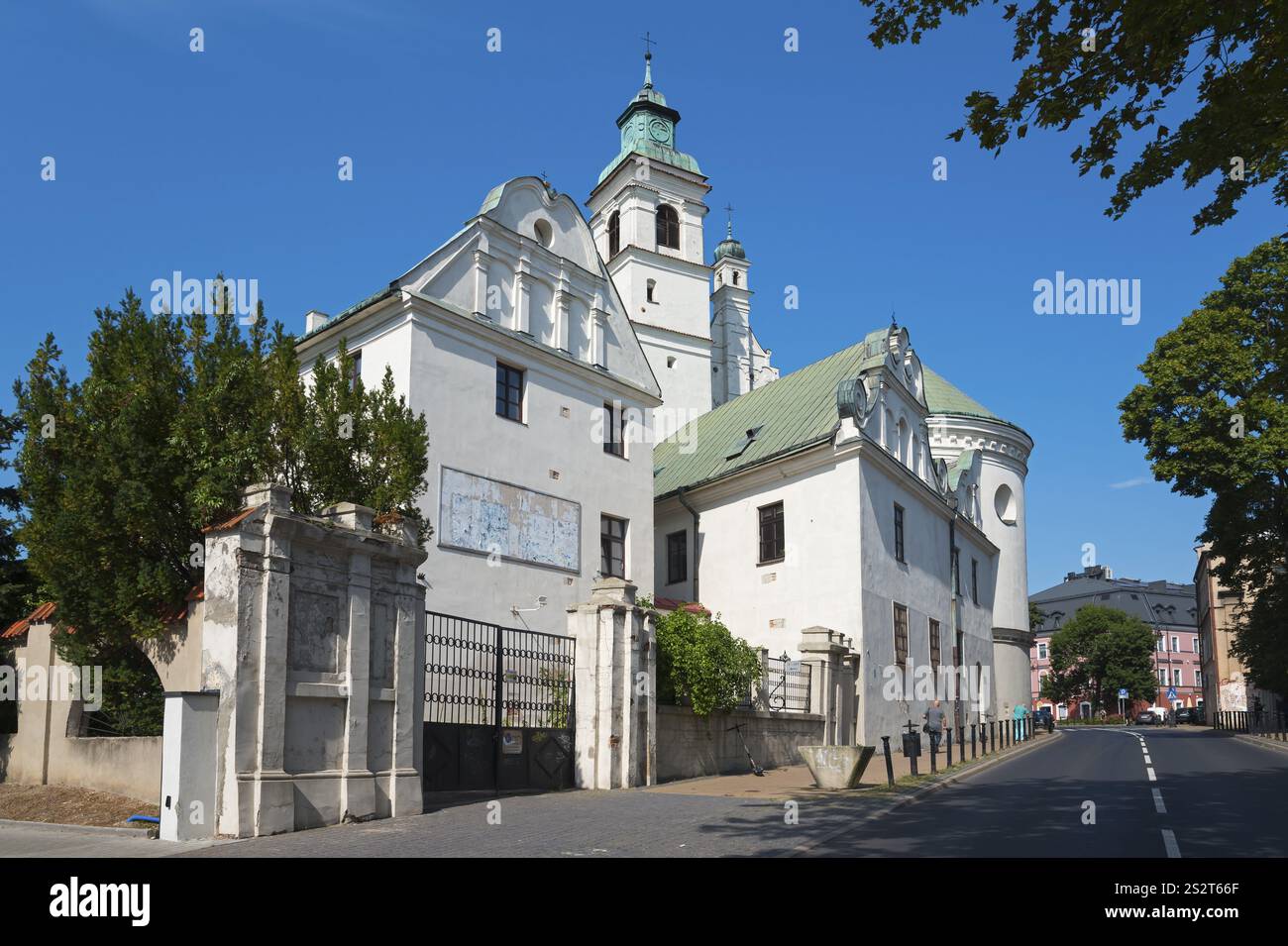 Baroque church with white brickwork and green roof, surrounded by trees ...