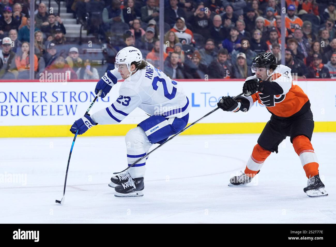 Toronto Maple Leafs' Matthew Knies, left, shoots the puck past ...