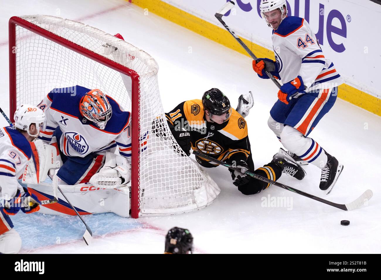 Boston Bruins center Trent Frederic (11) tries to control the puck as ...