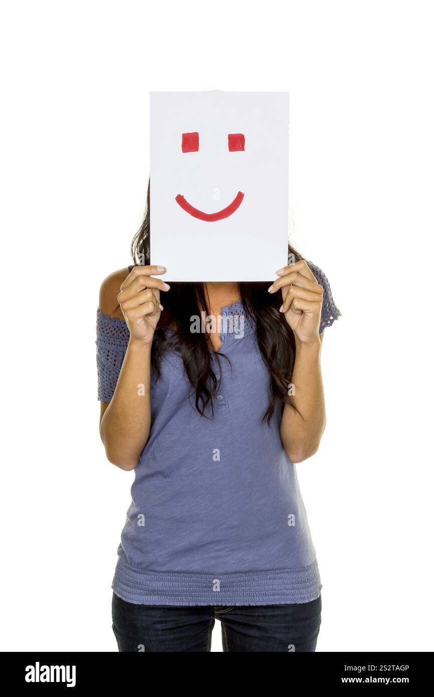 A young woman holds a note with a smiley in front of her face Austria ...