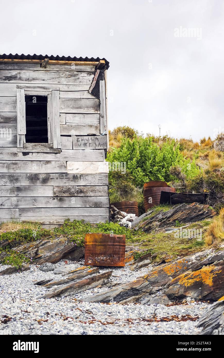Vertical shot of a wooden shack with sheet roof and no door in Ushuaia ...