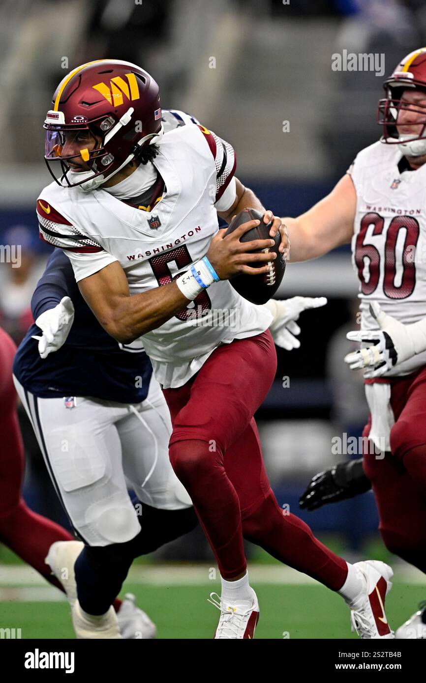 Washington Commanders quarterback Jayden Daniels (5) runs with the ball ...