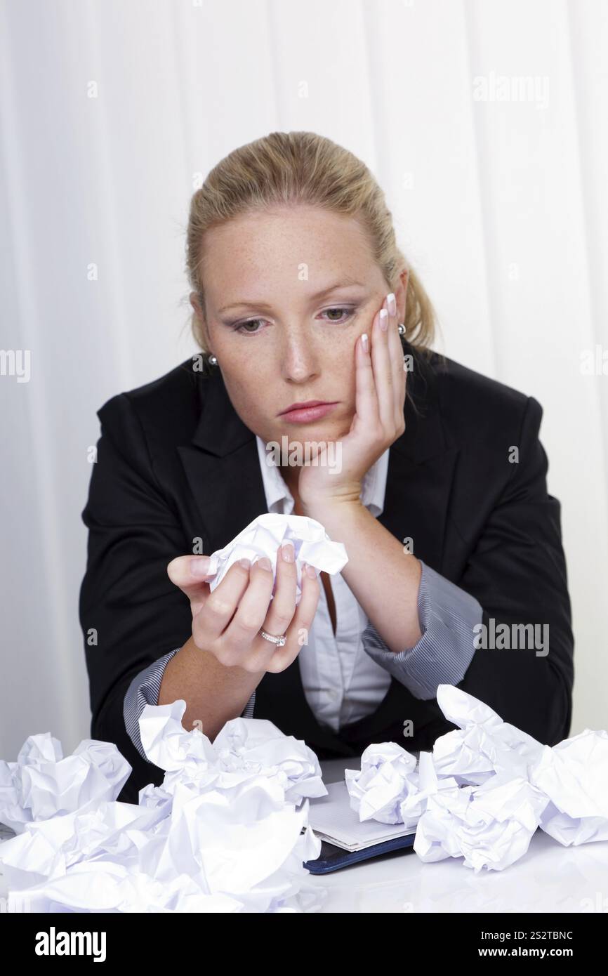 A woman in the office with a ball of paper. Anger, stress and ...