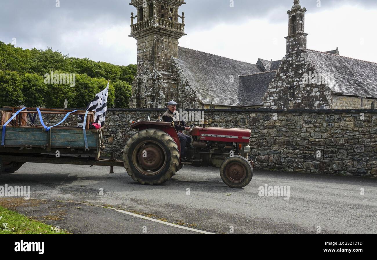 Old tractor Massey Ferguson with trailer in front of church and chapel ...