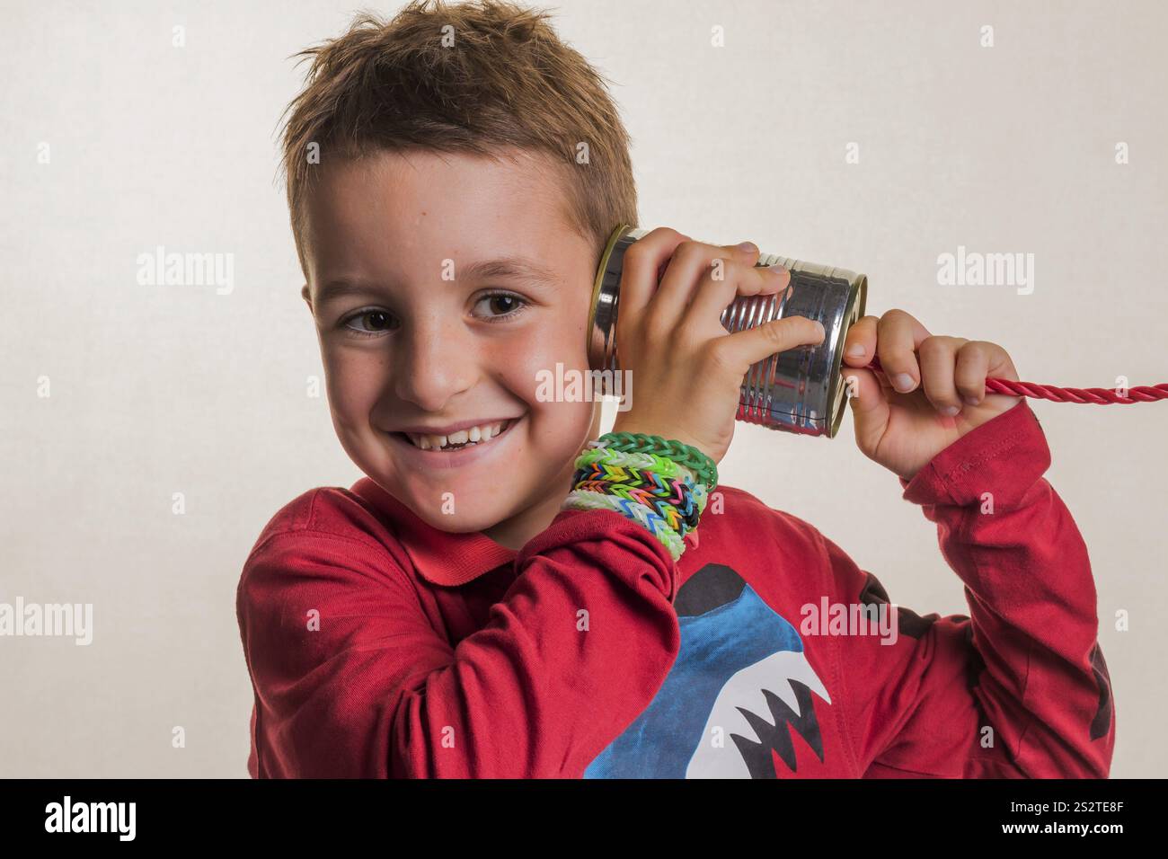 Child listening into a tin can telephone. Austria Stock Photo - Alamy