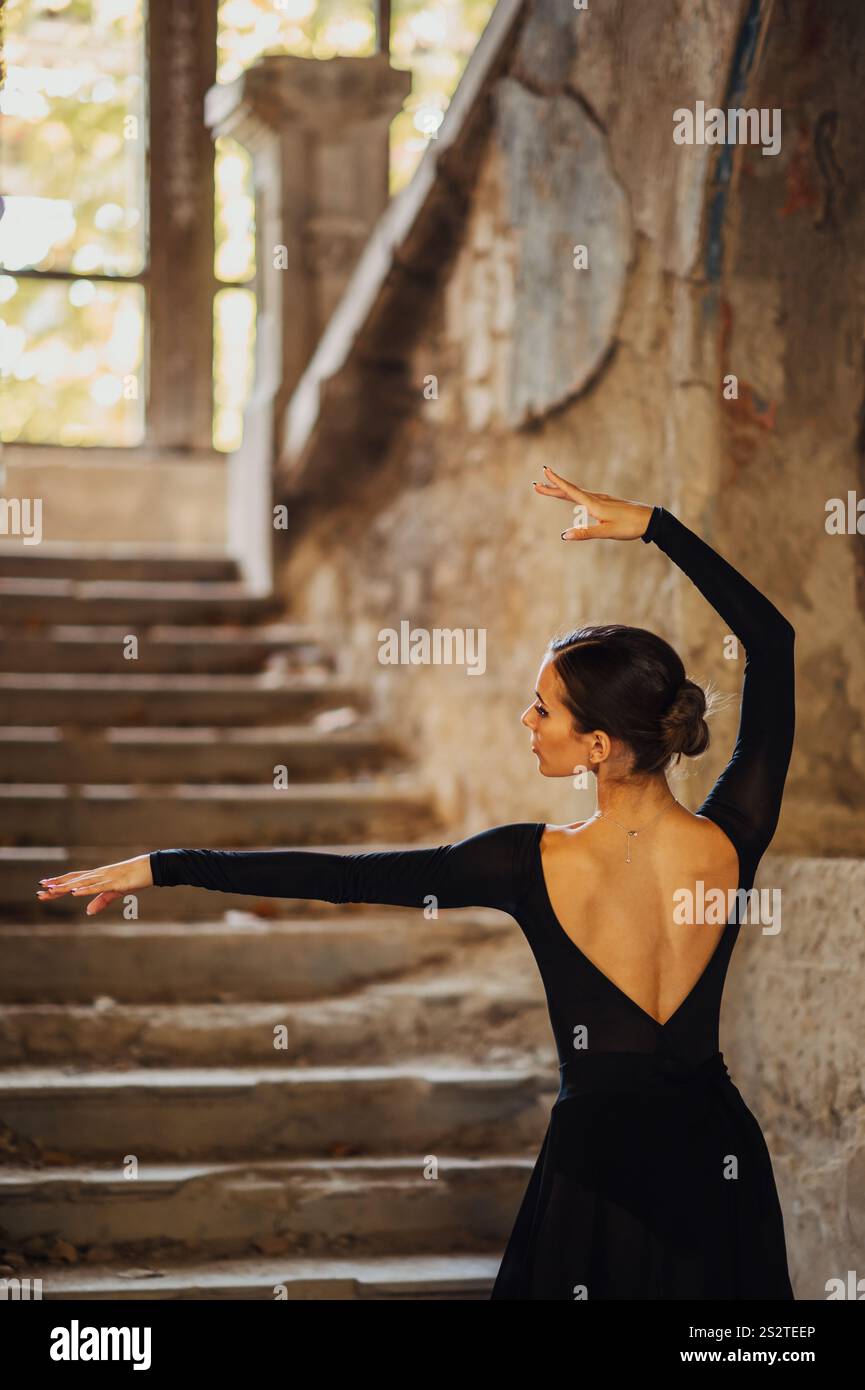 Rear view of a gracious and elegant prima ballerina performing her ...