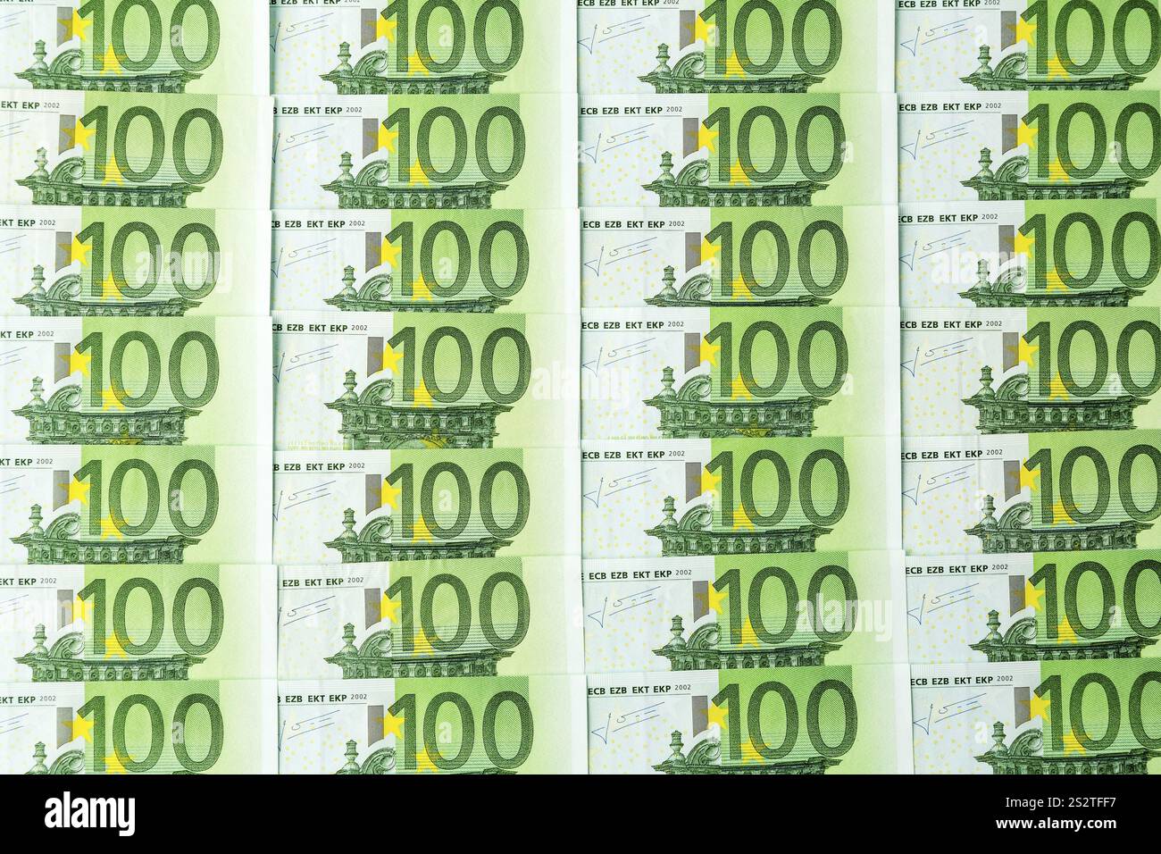 Many one hundred euro banknotes lying next to each other. Symbolic ...