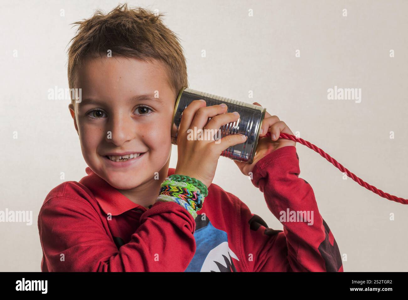 Child listening into a tin can telephone. Austria Stock Photo - Alamy