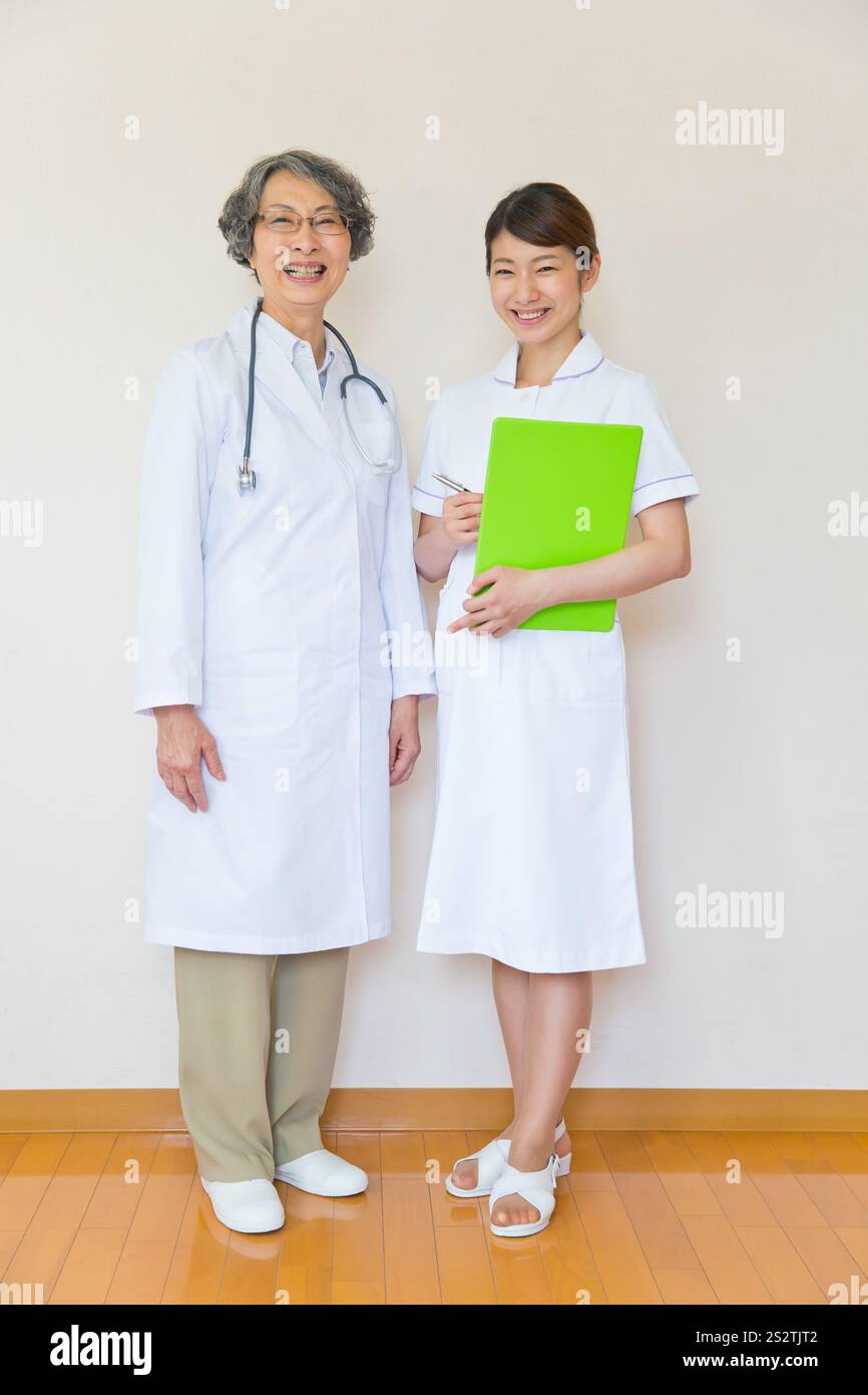 Female doctor and nurse standing side by side Stock Photo - Alamy
