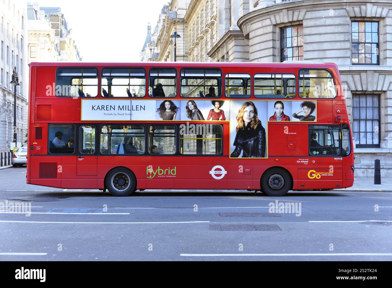 A red double-decker bus travelling on a city street, London, London ...