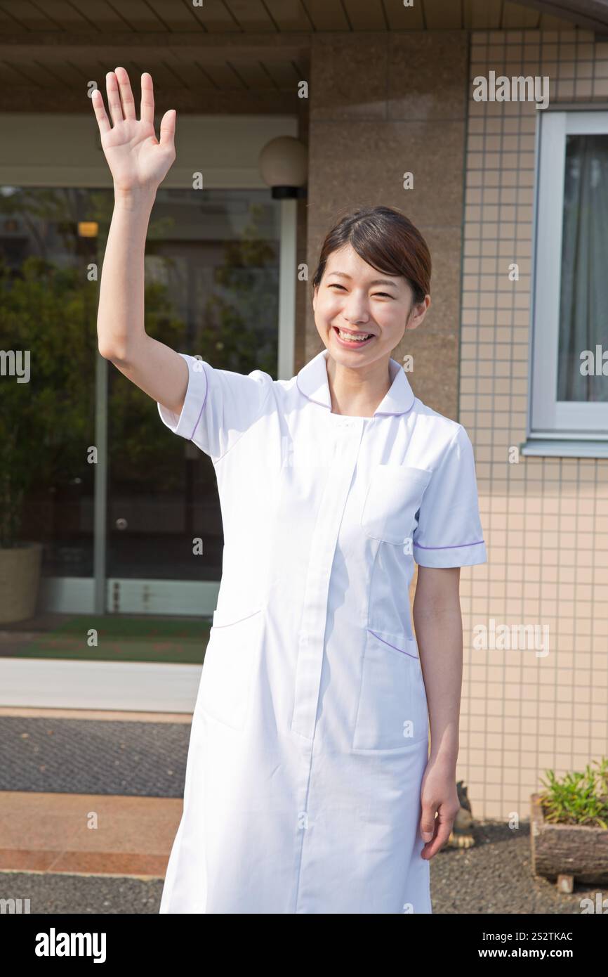 Nurses waving in front of the hospital Stock Photo - Alamy