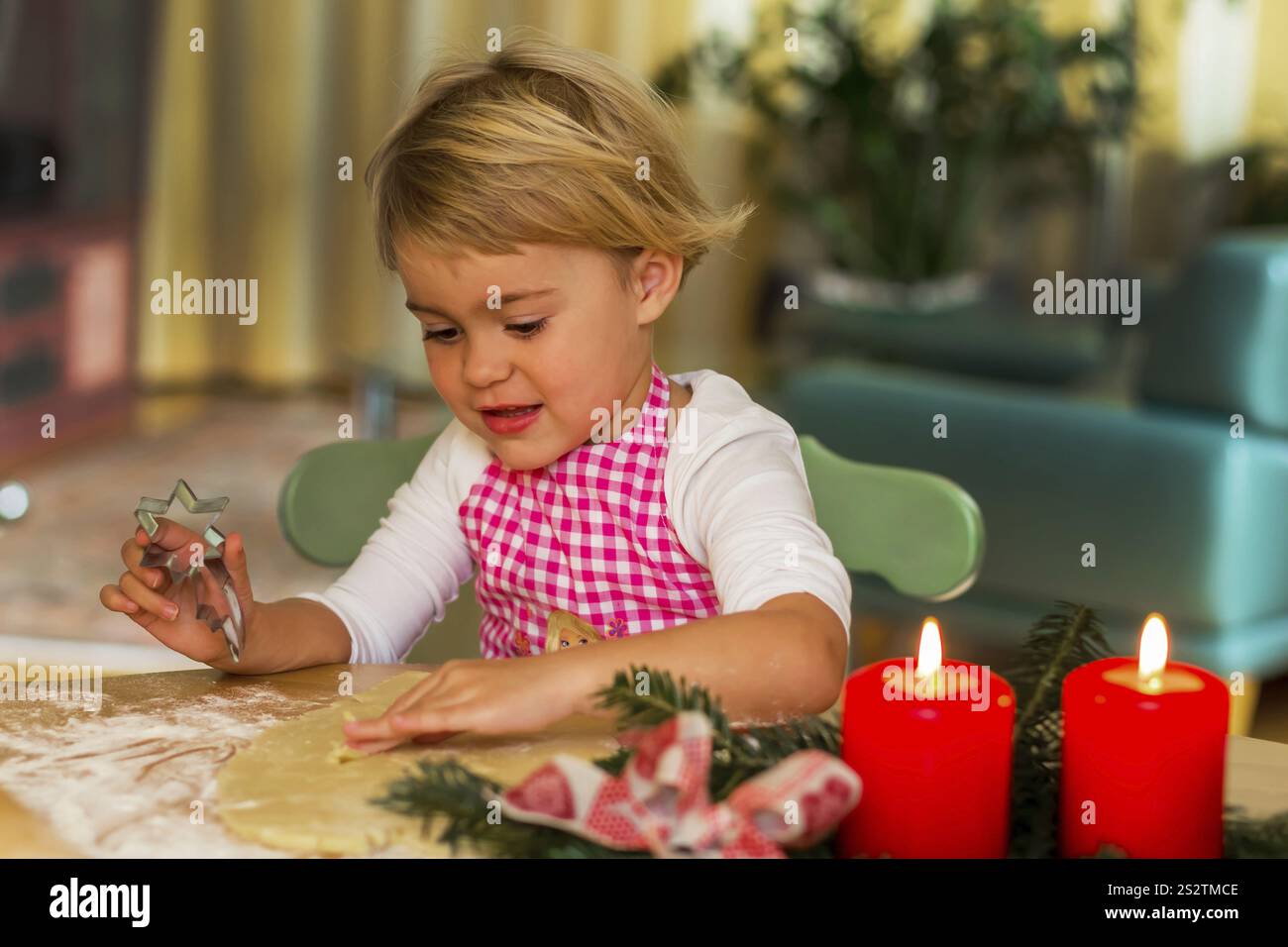 Child baking biscuits for Christmas. Biscuits for the Advent season ...