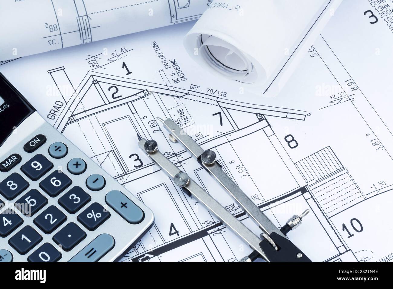 An architect's construction plan with a calculator. Symbolic photo for ...
