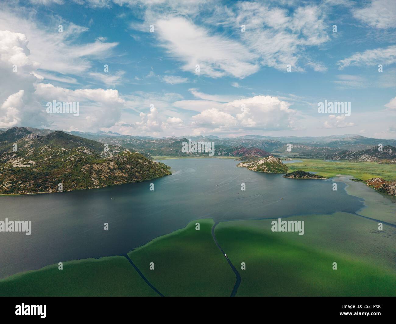 Aerial view of a lake and a nature around it. From above, the water is ...