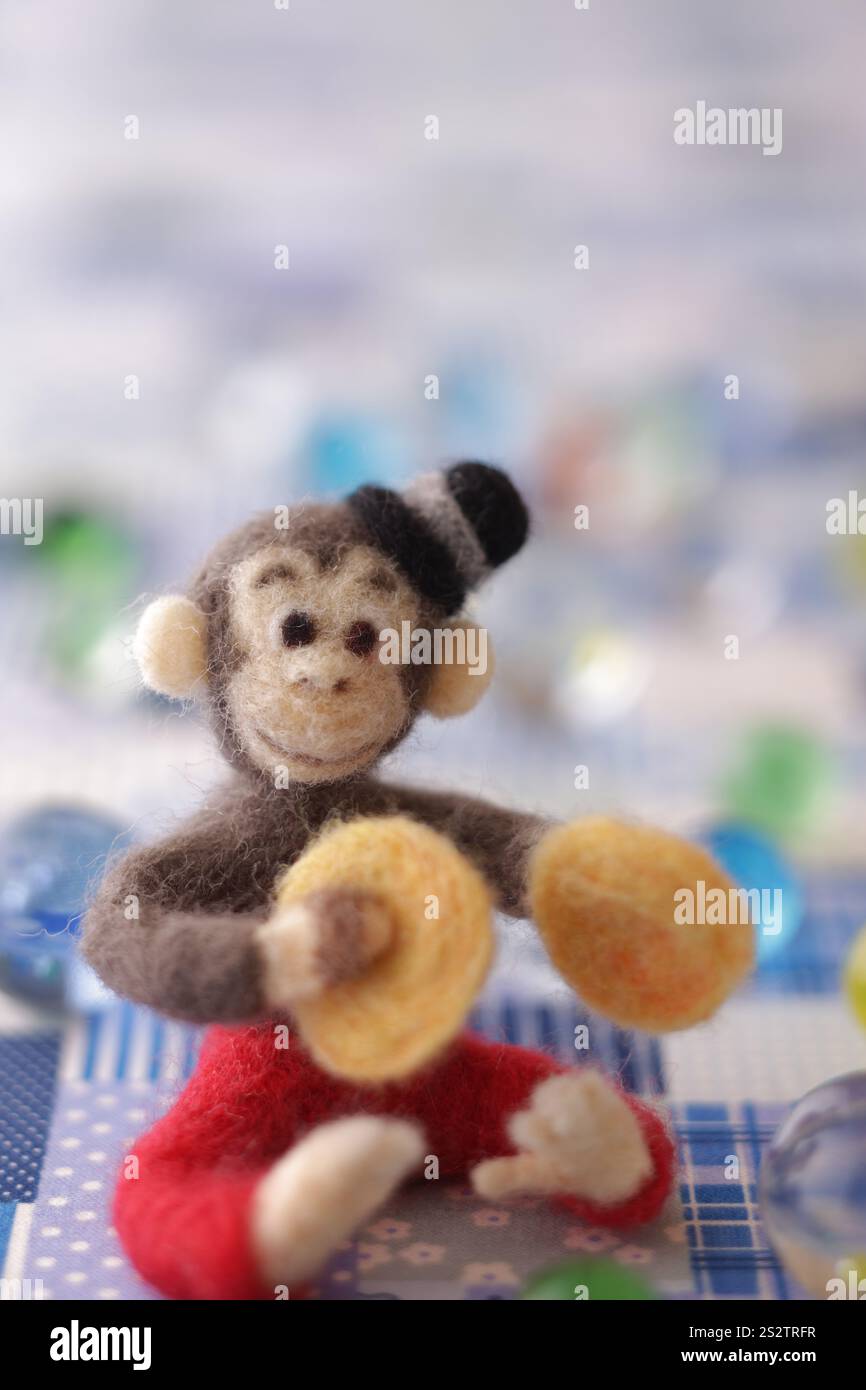 Felt monkey and chequered background Stock Photo - Alamy