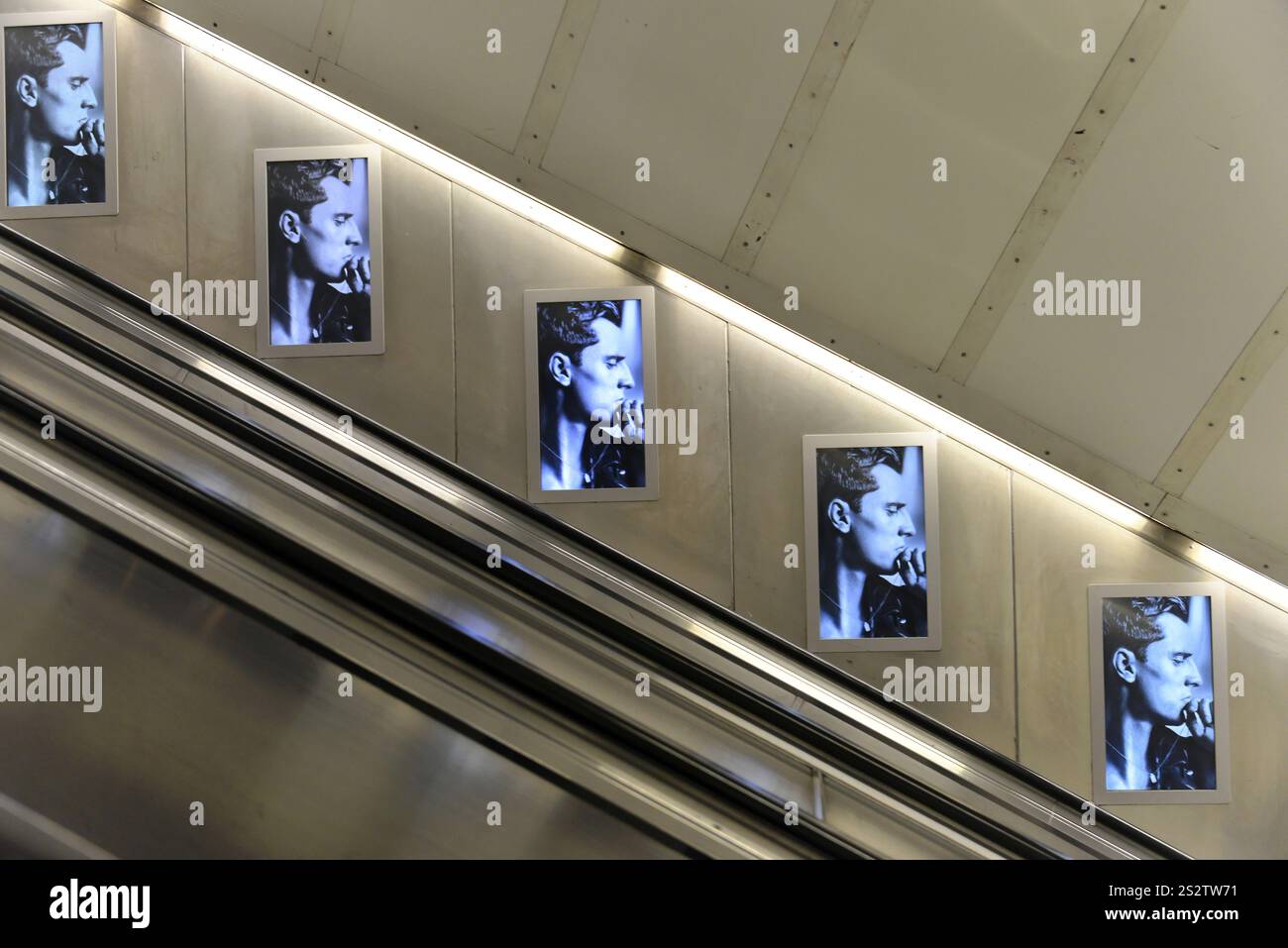 Escalator in the underground with illuminated black and white ...