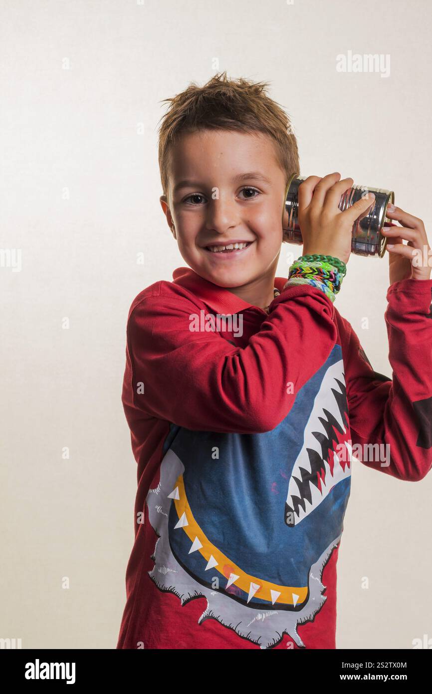 Child listening into a tin can telephone. Austria Stock Photo - Alamy