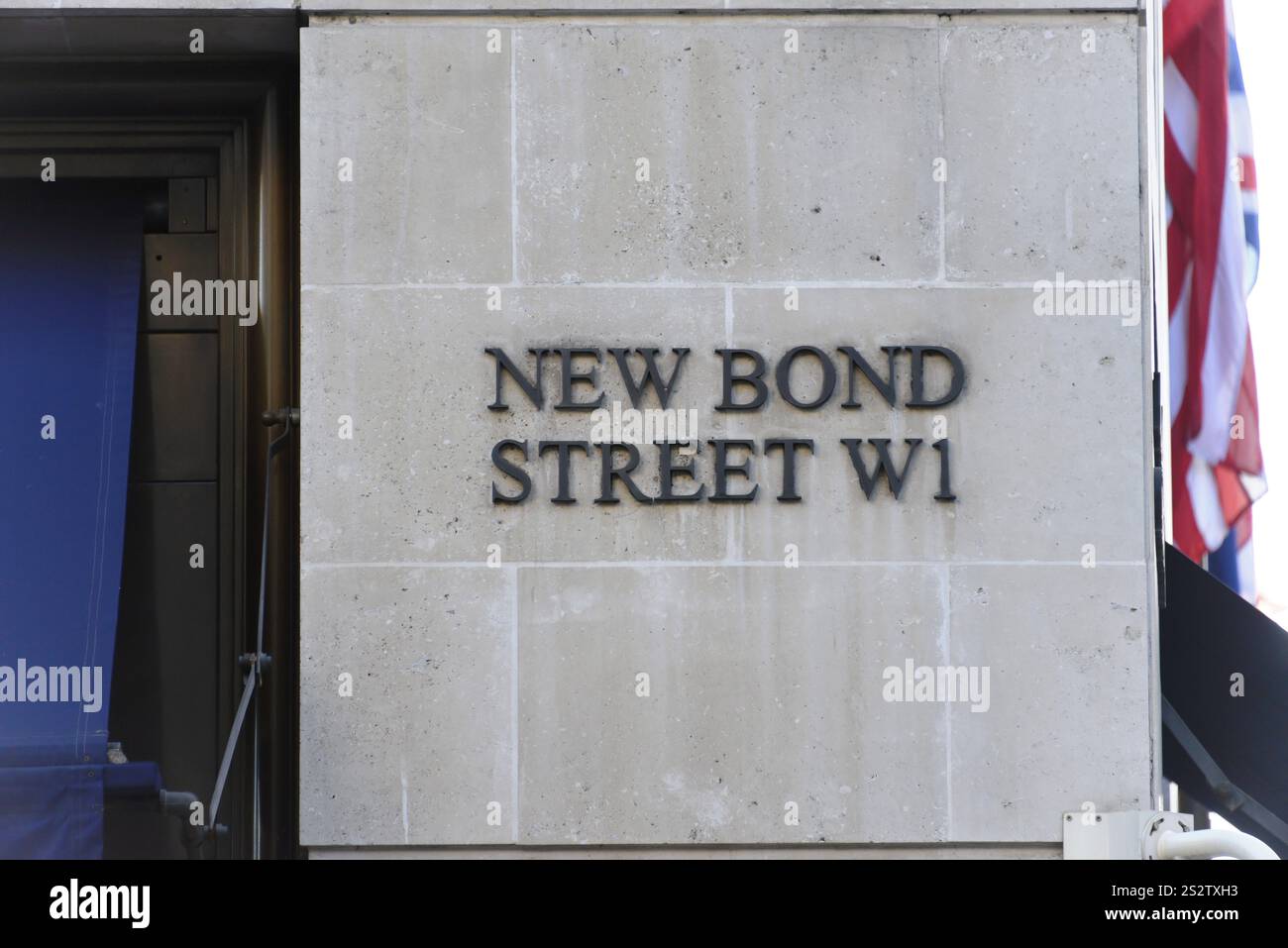Plain stone wall sign with street name, urban environment, London ...