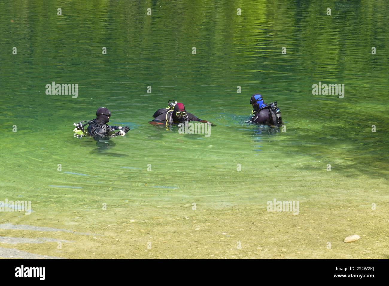 Divers get ready for a dive in a lake. Austria, Upper Austria ...