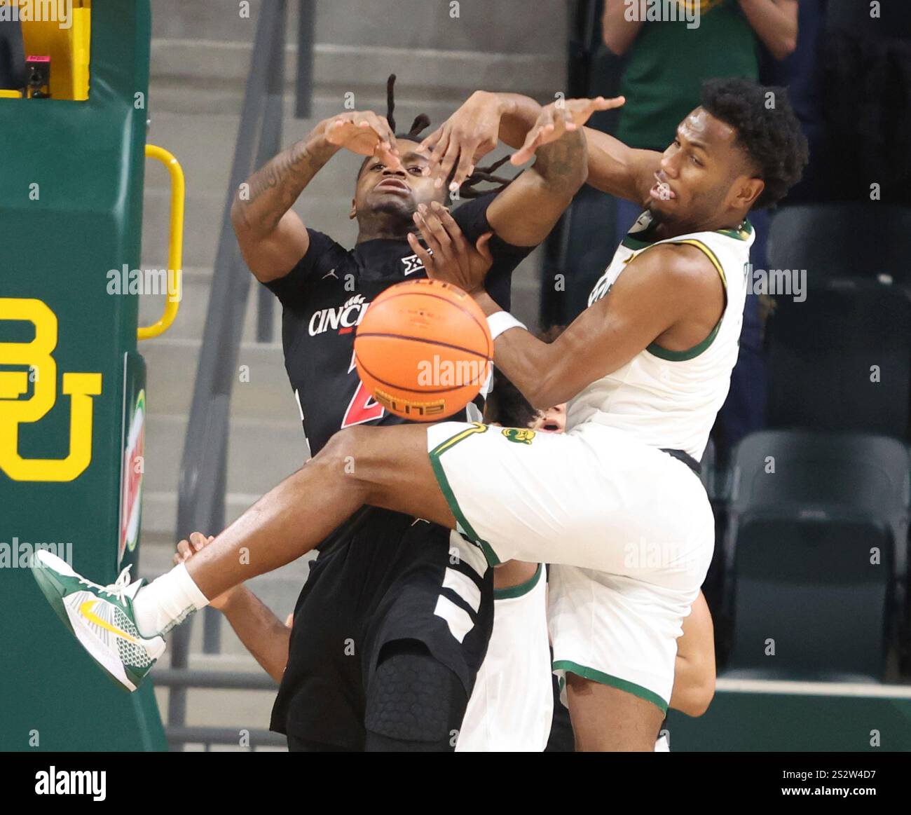 Cincinnati guard Jizzle James battles Baylor guard Jeremy Roach for a ...