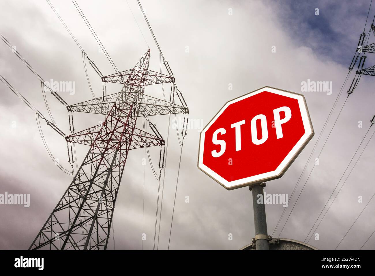 A pylon of a power line and a stop sign. Symbolic photo for phasing out ...