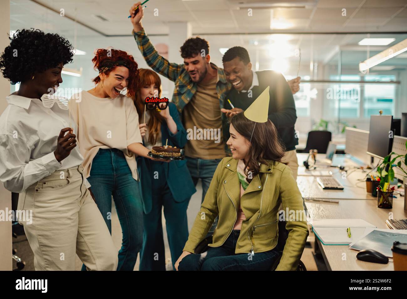 A multicultural businesspeople celebrating birthday and bringing a ...