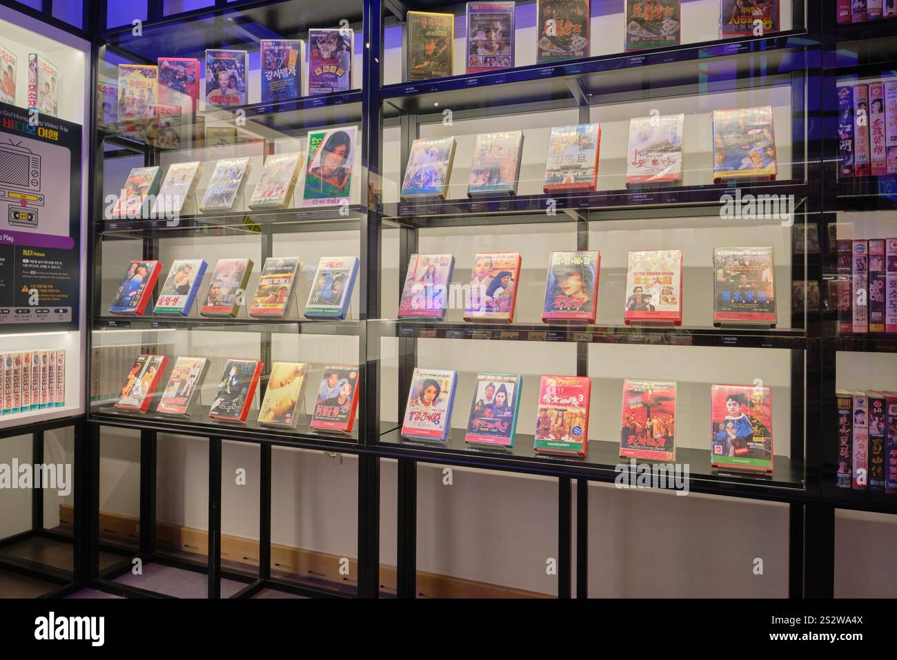 A recreation of a VHS, Beta cassette tape, movie rental store. In a pop ...