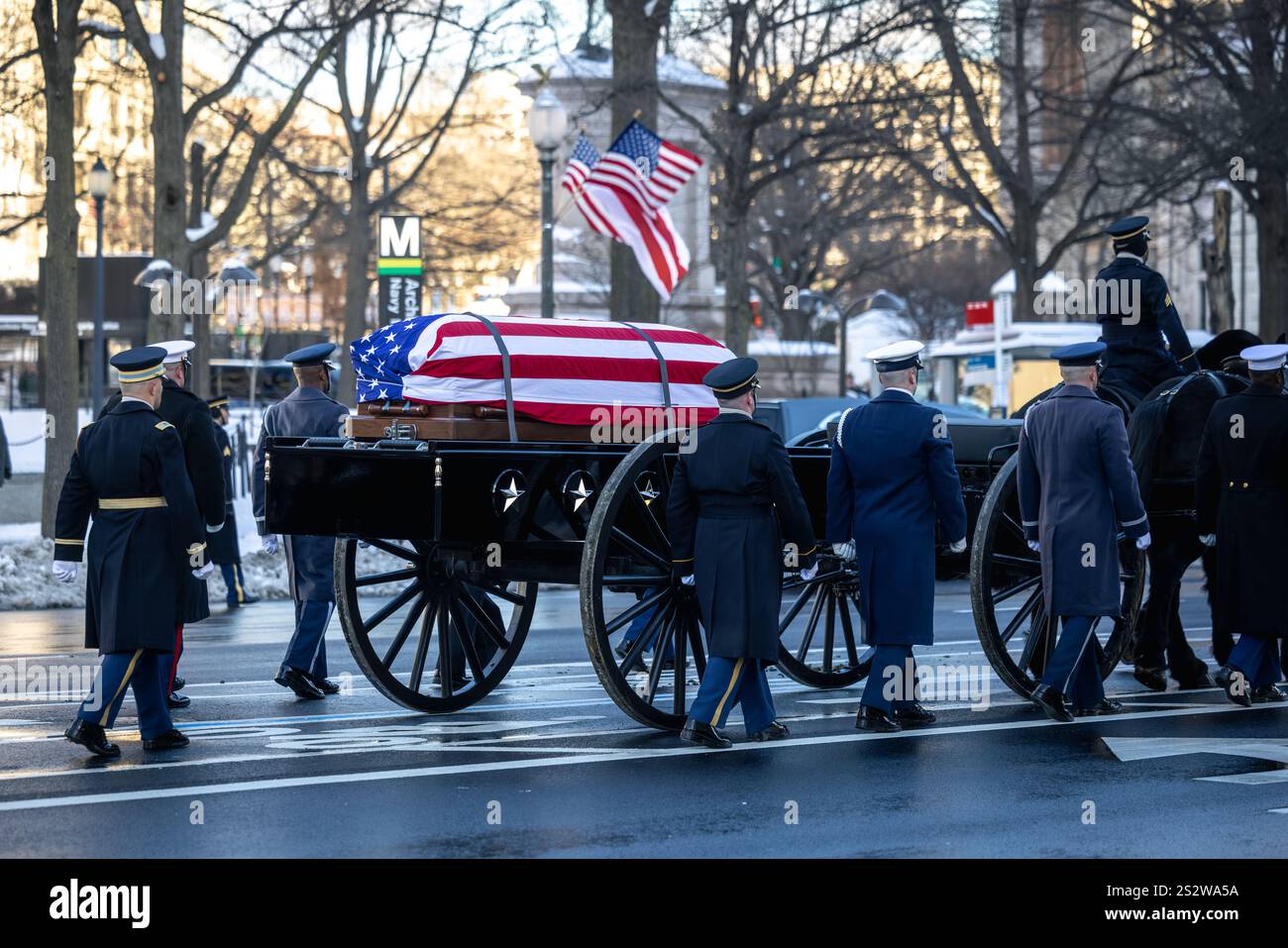U.S. service members march alongside the casket of 39th President Jimmy ...