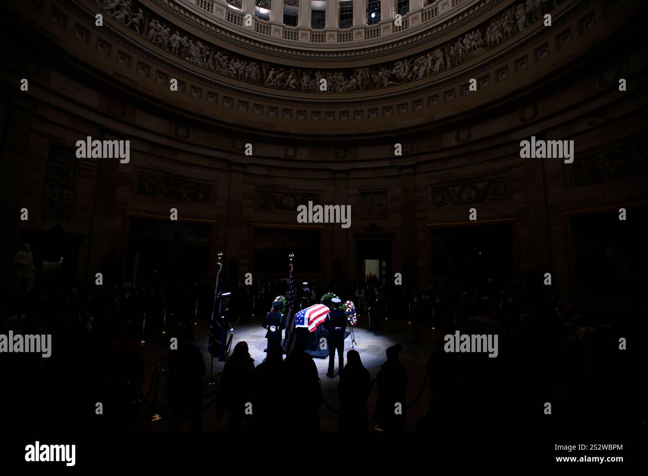 A spotlight iluminates the flag-draped casket to pay tribute toformer ...