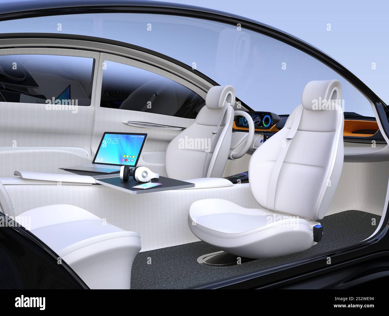 Front seats of an automated vehicle facing backwards, laptop on a ...