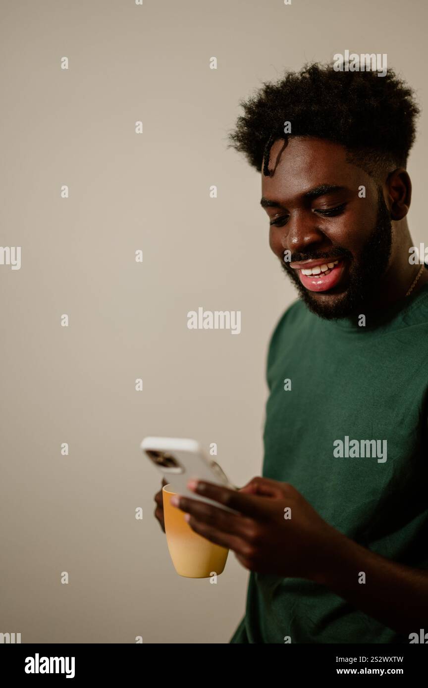 A happy multicultural millennial guy is standing isolated on a white ...