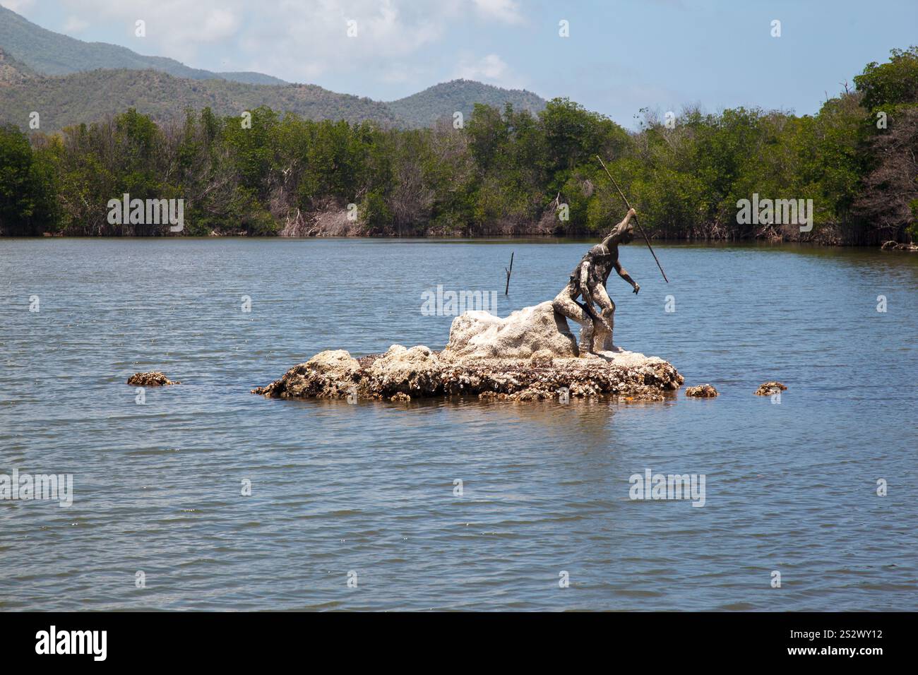 The Statue of an aboriginal couple fishing in Baconao lake in Santiago ...