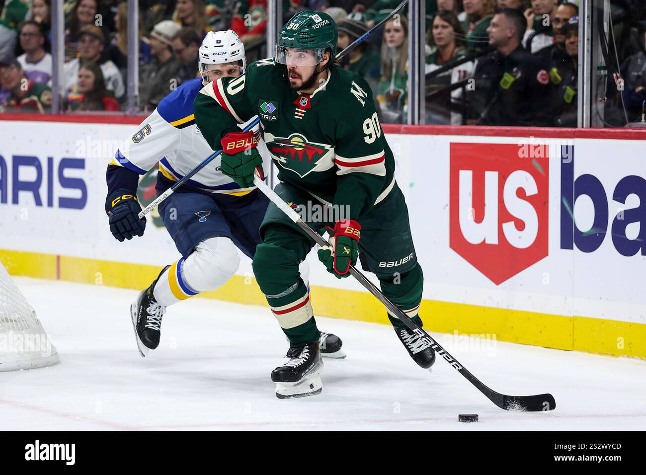 Minnesota Wild center Marcus Johansson, right, skates with the puck ...