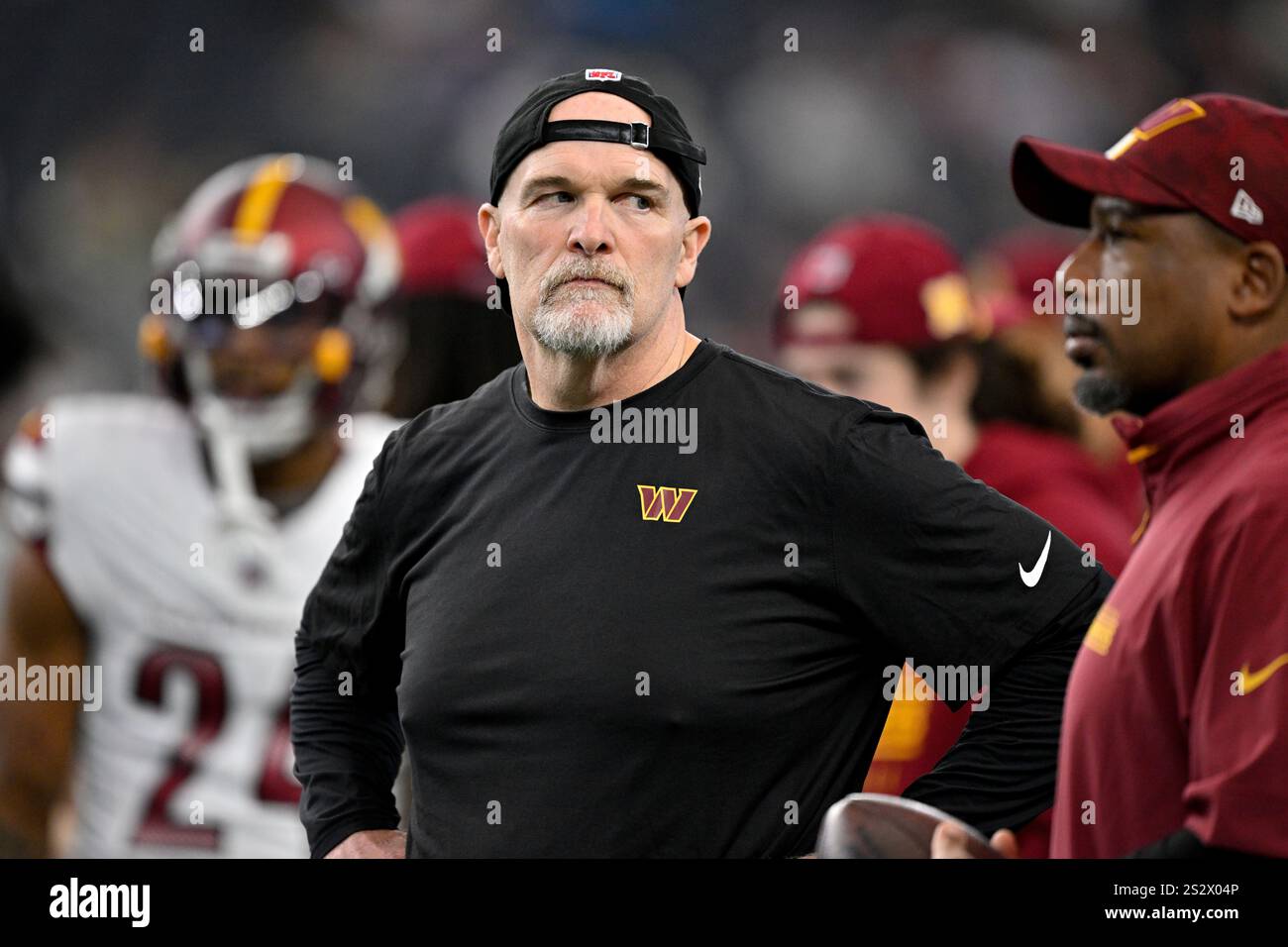 Washington Commanders Dan Quinn looks on as his team warms up before an ...